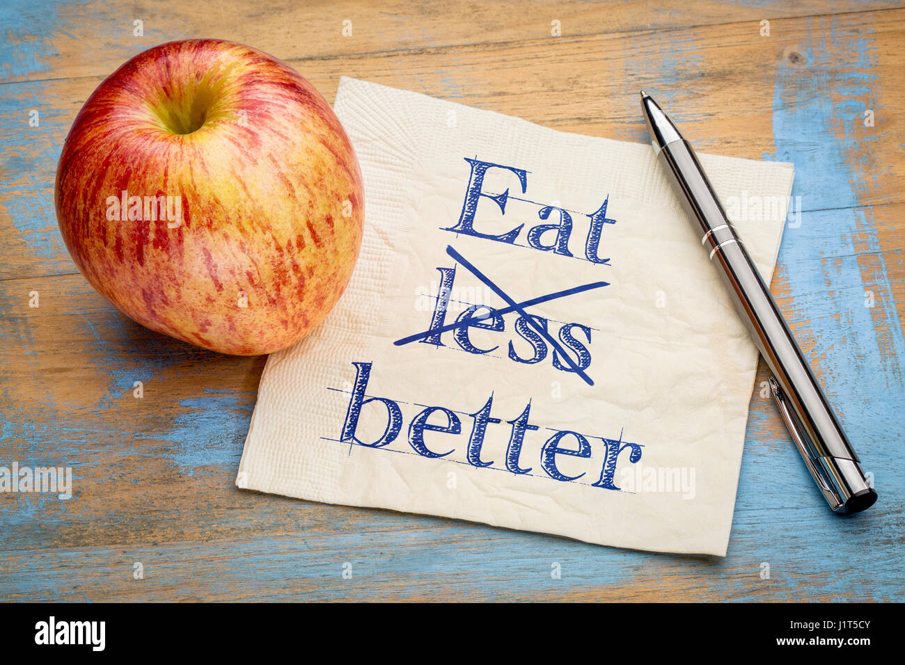 Eat better, not less - handwriting on a napkin with a fresh apple Stock ...