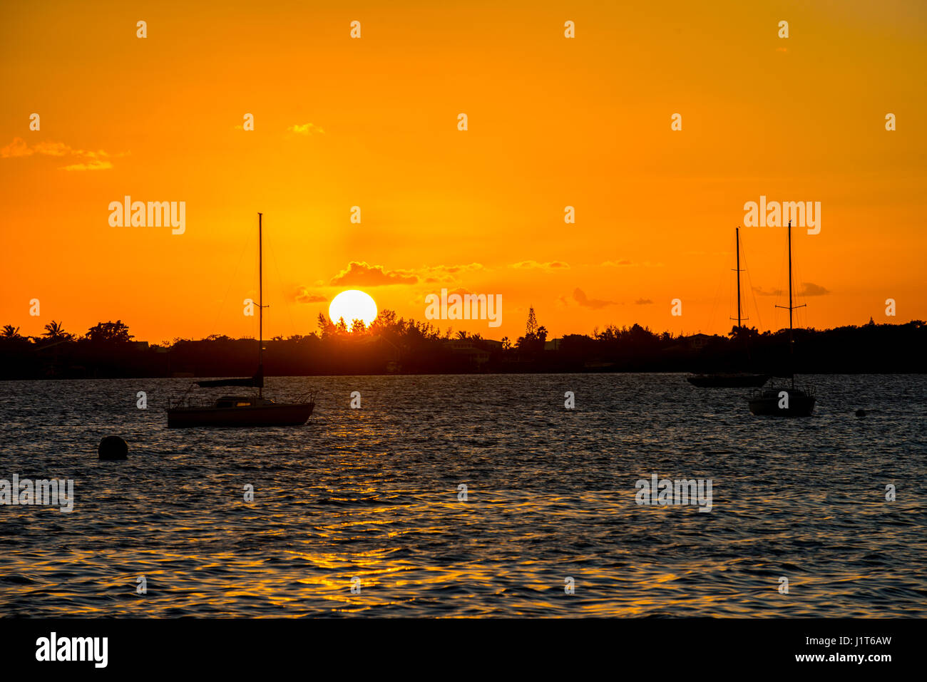 sunset over key largo bay with sailnoats anchored in bay Stock Photo ...