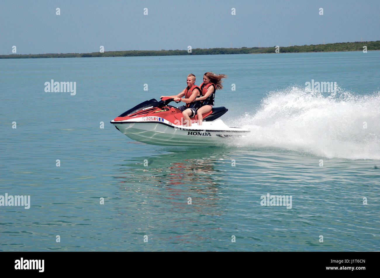 jet ski with two people on it Stock Photo - Alamy
