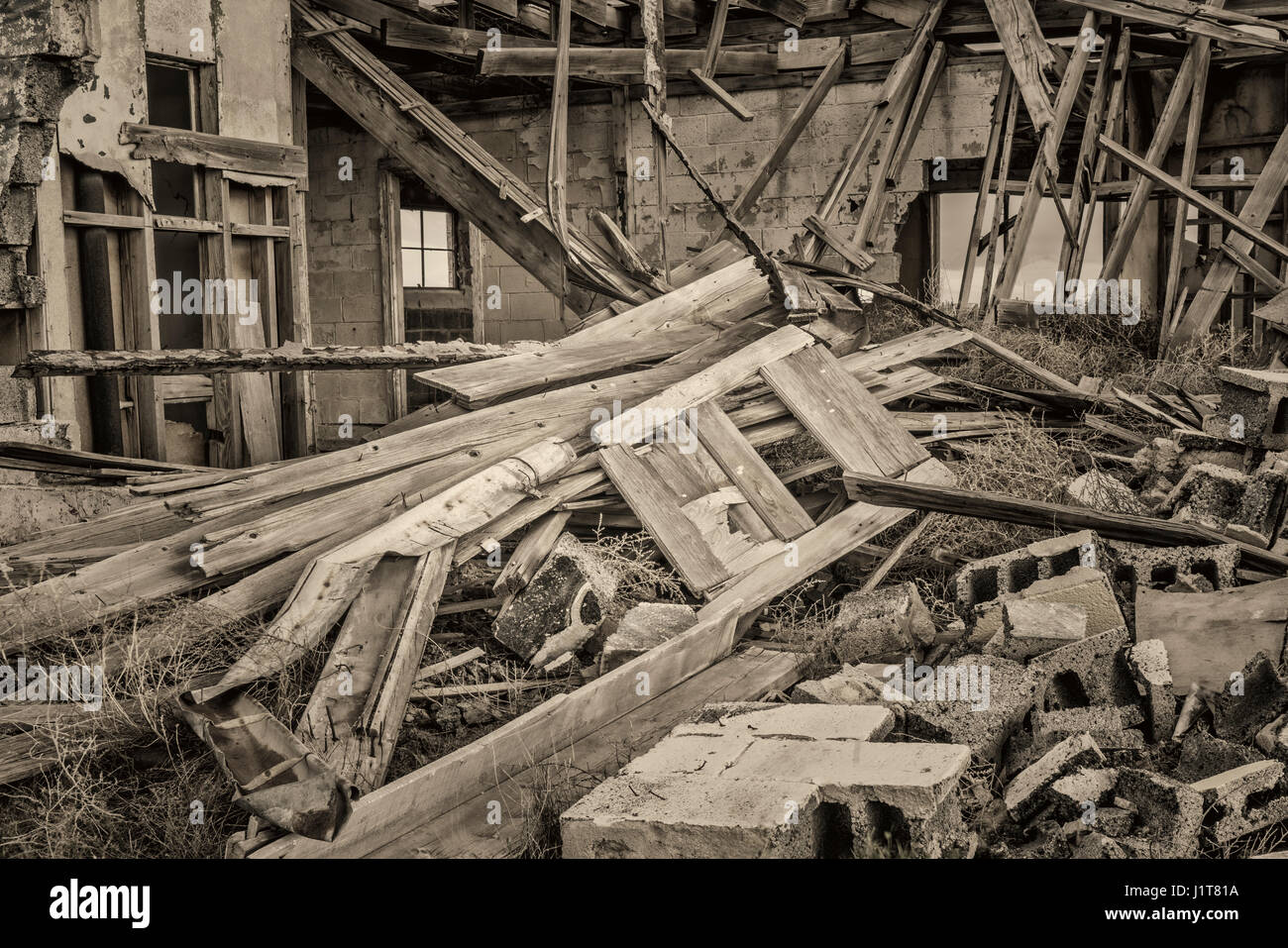collapsed old house in a ghost town in the southwest USA, black and ...