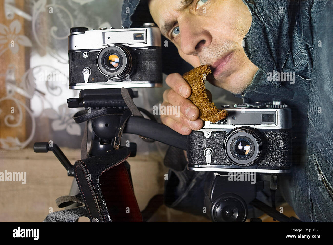 Photographer holding a slice of bread in his studio, concept of work ...