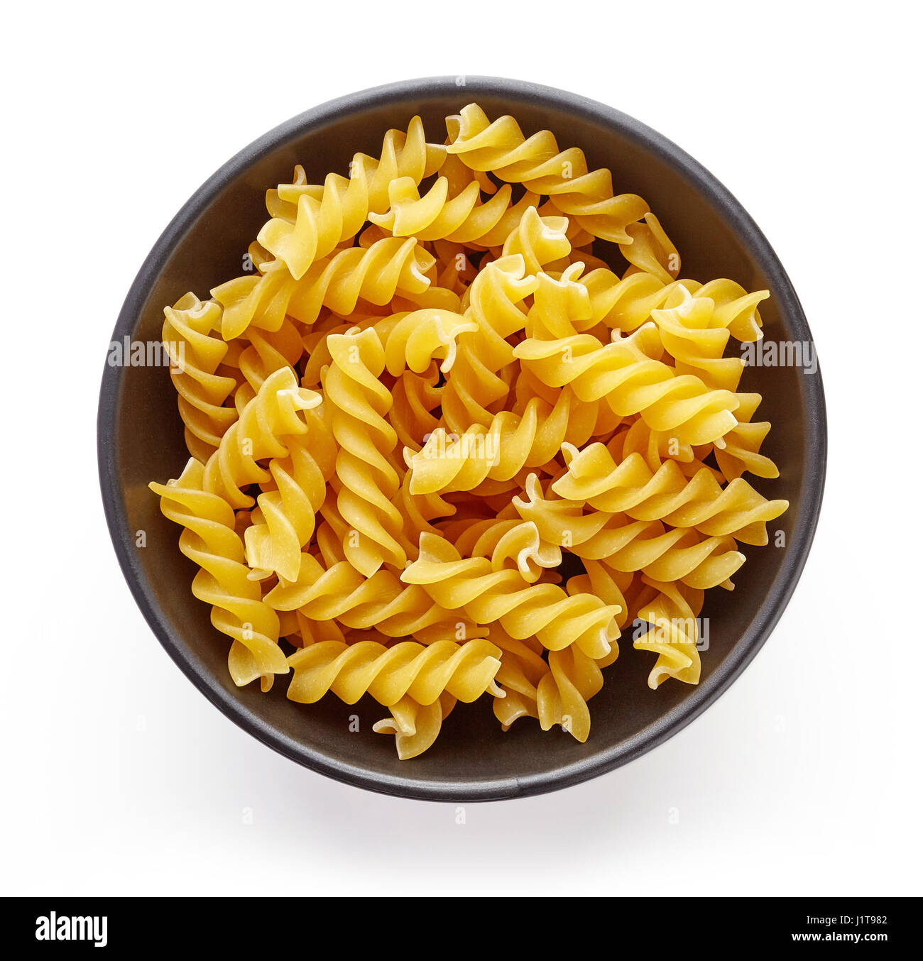 spiral pasta in bowl, isolated on white background, top view Stock ...