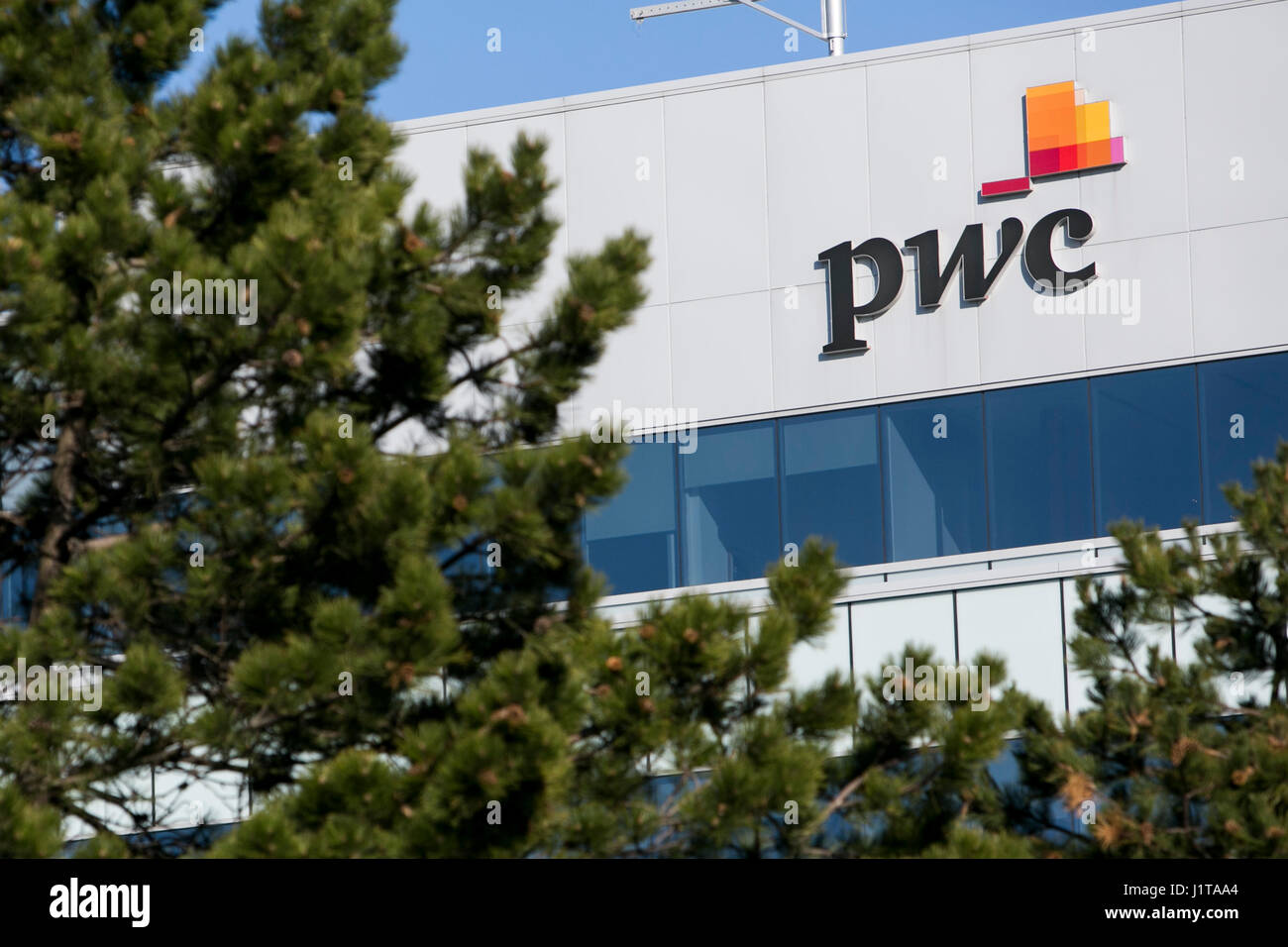 A logo sign outside of a facility occupied by PricewaterhouseCoopers ...