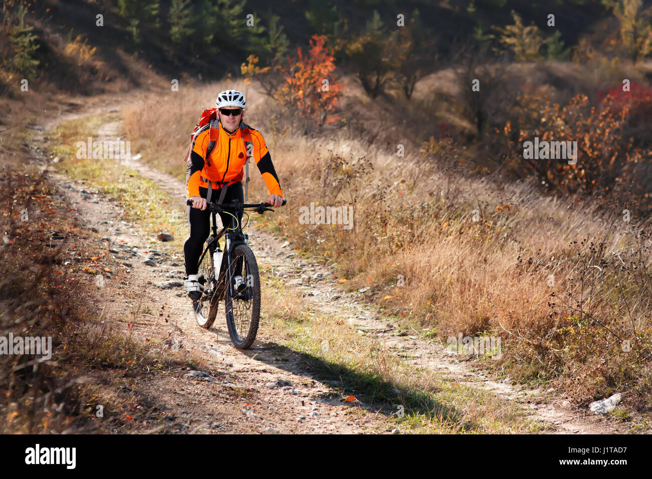 Cyclist in orange jacket hi-res stock photography and images - Alamy