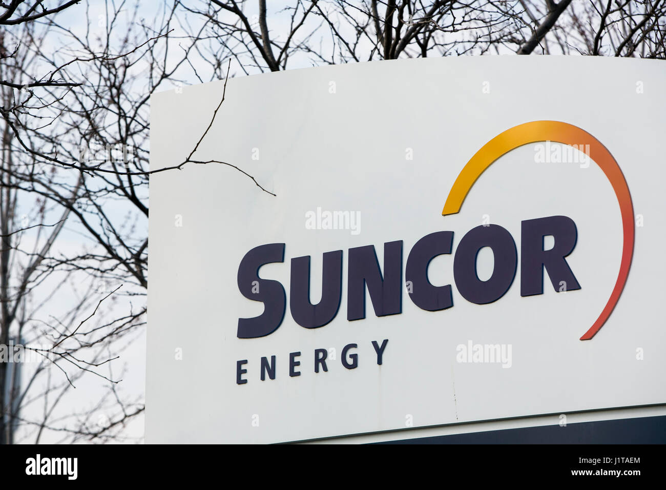 A logo sign outside of a facility occupied by Suncor Energy in ...