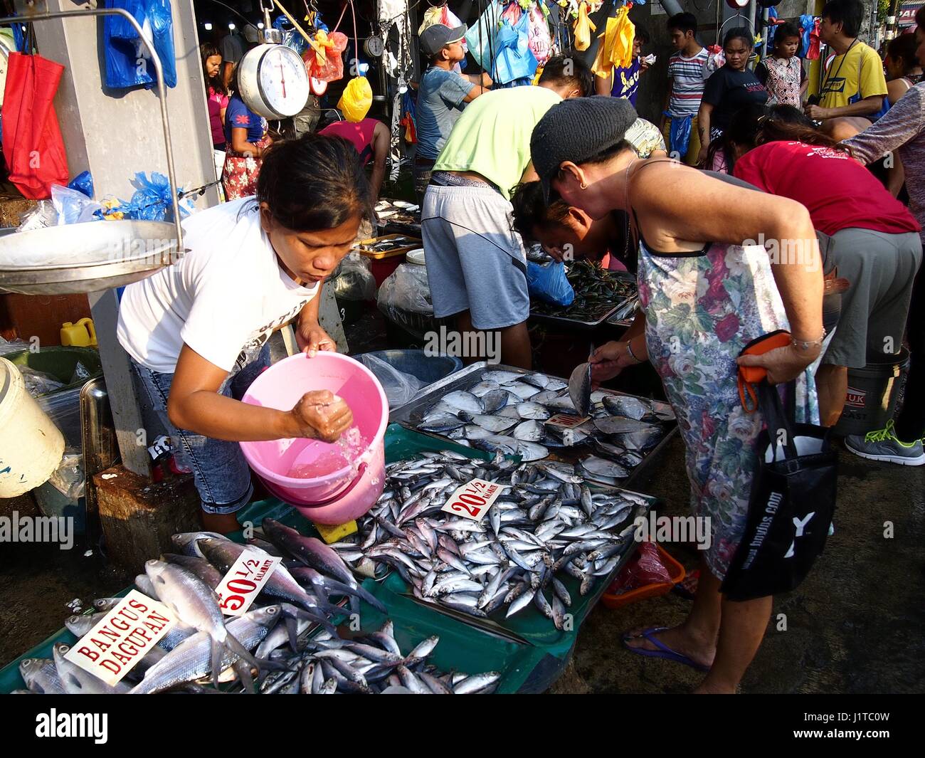 ANTIPOLO CITY, PHILIPPINES - APRIL 18, 2017: A wet market vendor sells ...