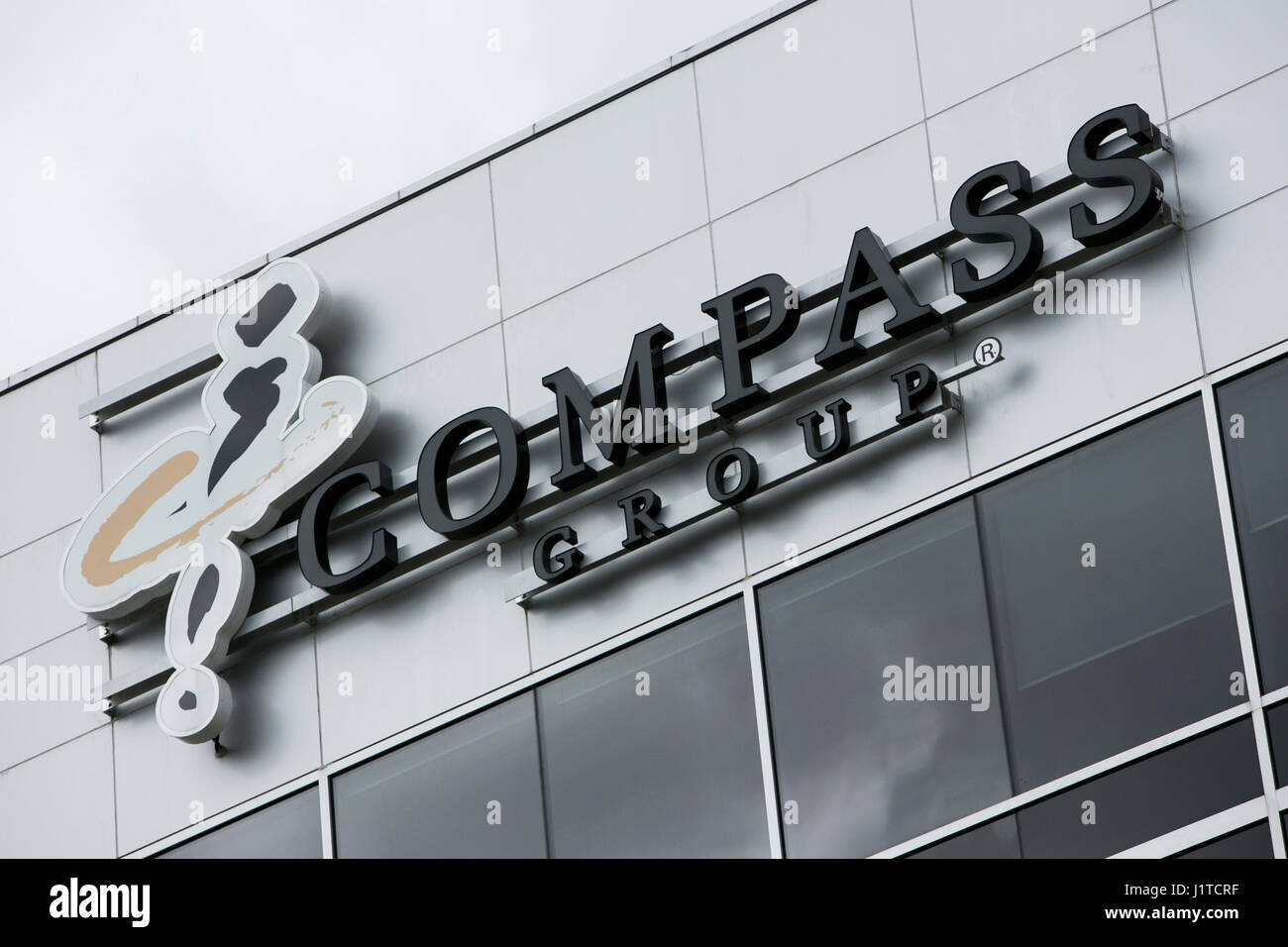 A logo sign outside of a facility occupied by the Compass Group in ...