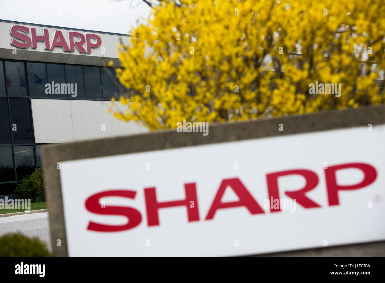 A logo sign outside of a facility occupied by the Sharp Corporation in ...
