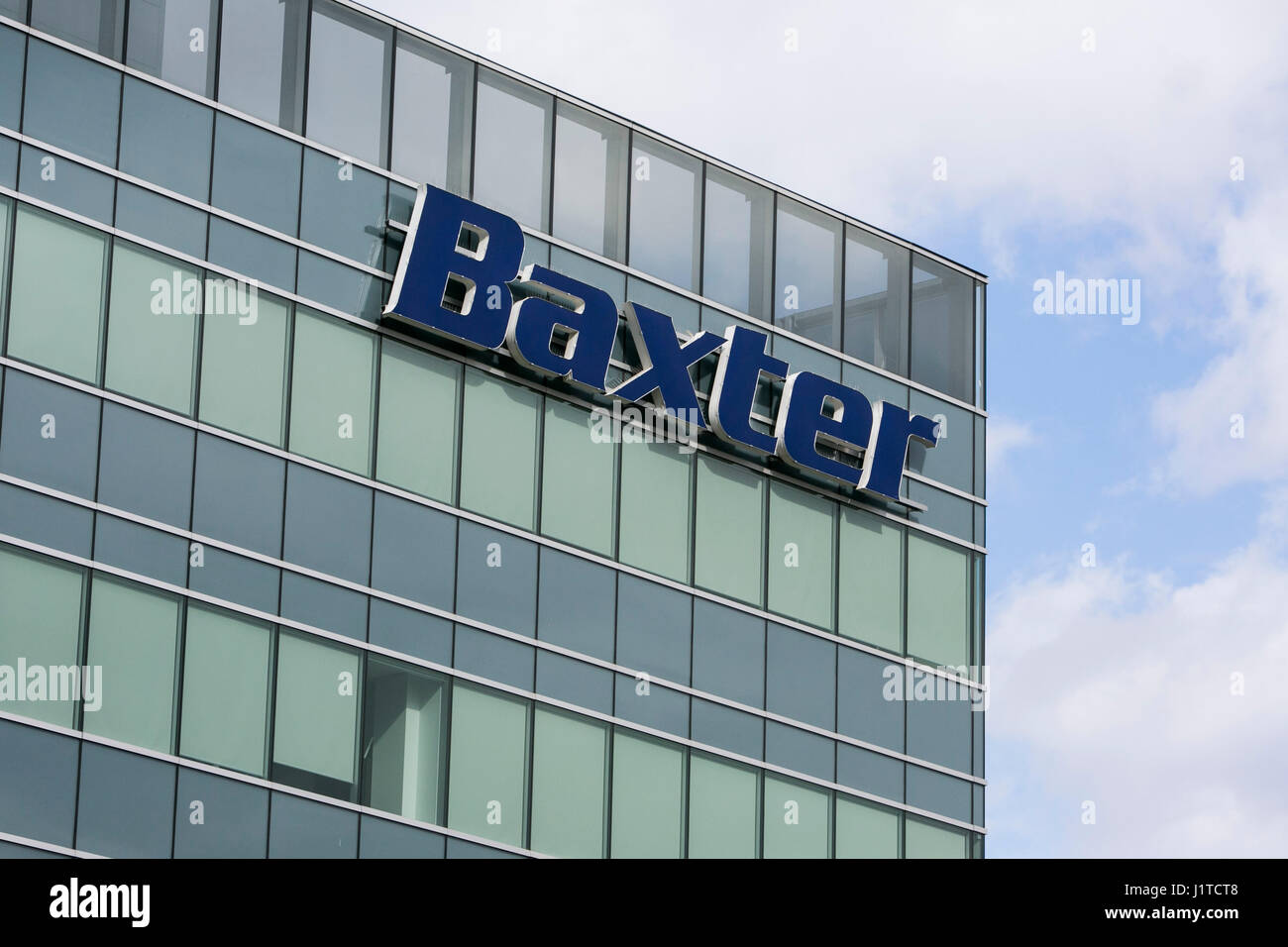 A logo sign outside of a facility occupied by Baxter International Inc ...