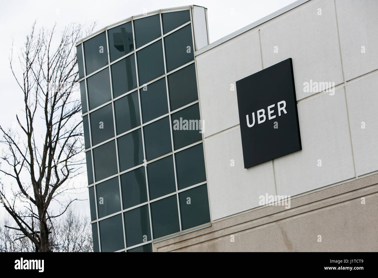 A logo sign outside of a facility occupied by Uber Technologies Inc ...