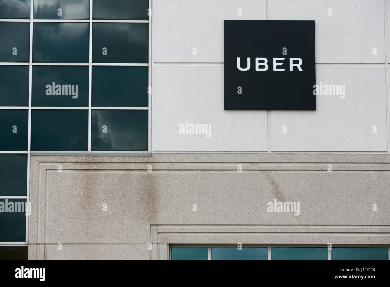 A logo sign outside of a facility occupied by Uber Technologies Inc ...