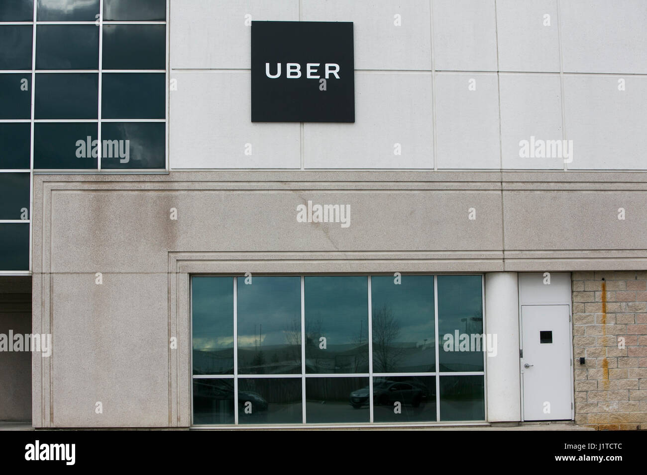 A logo sign outside of a facility occupied by Uber Technologies Inc ...