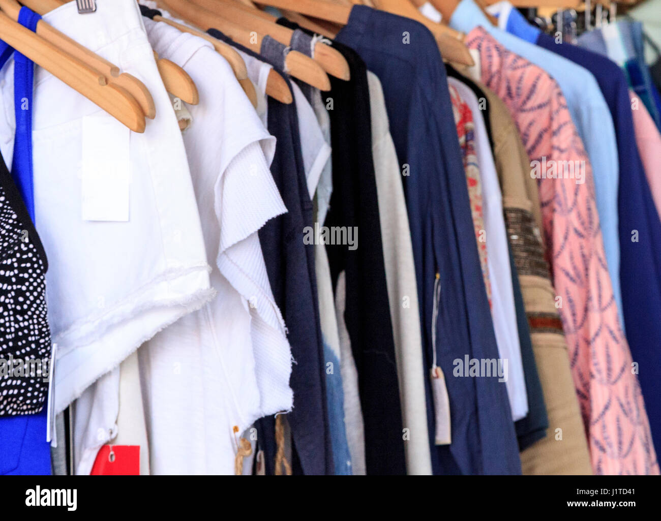 Women’s clothing rack of colorful fabrics outside in the summer Stock ...