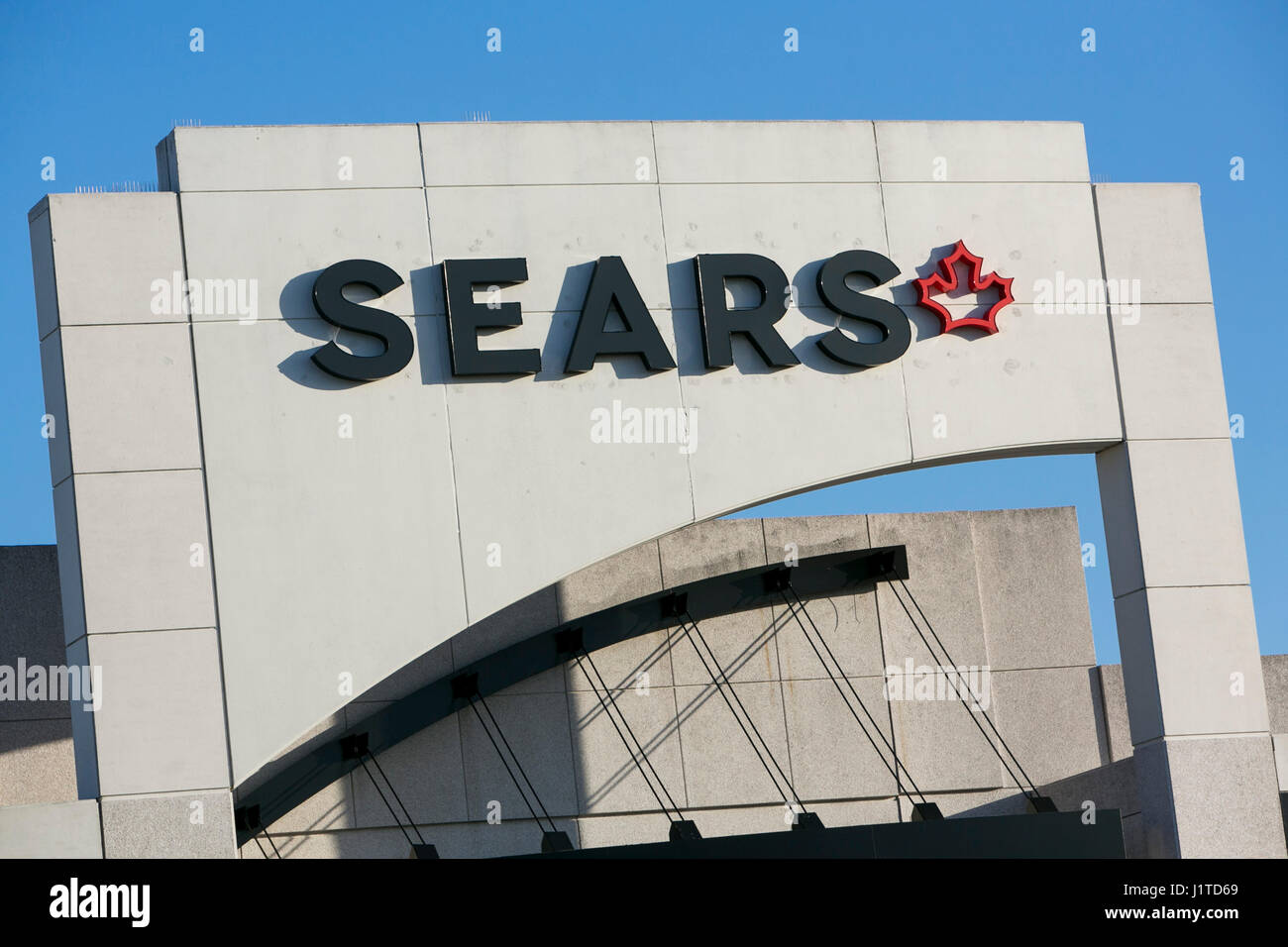 A logo sign outside of a Sears retail store in Burlington, ON, Canada ...