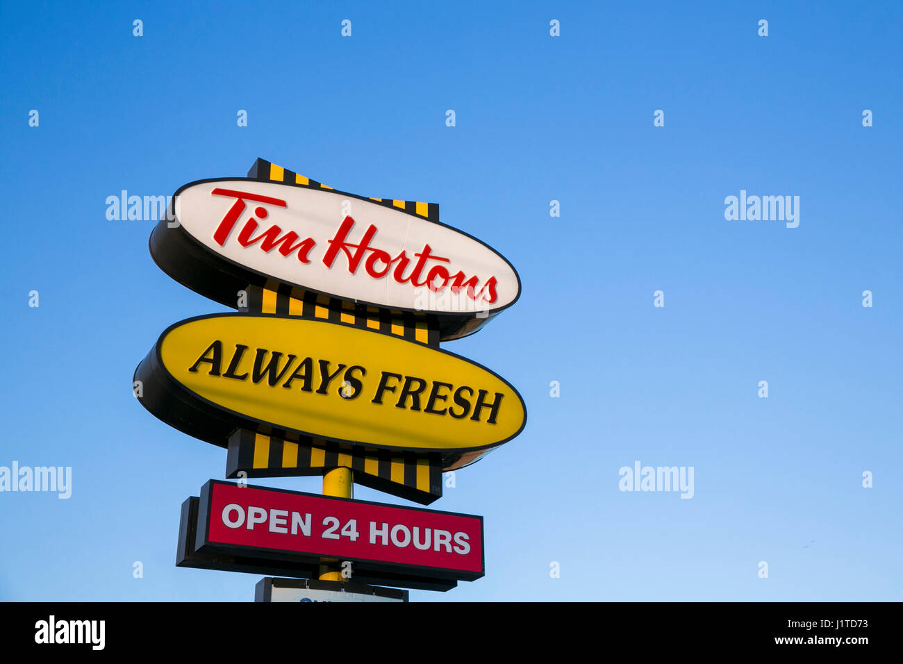 A logo sign outside of a Tim Hortons restaurant in Oakville, ON, Canada ...