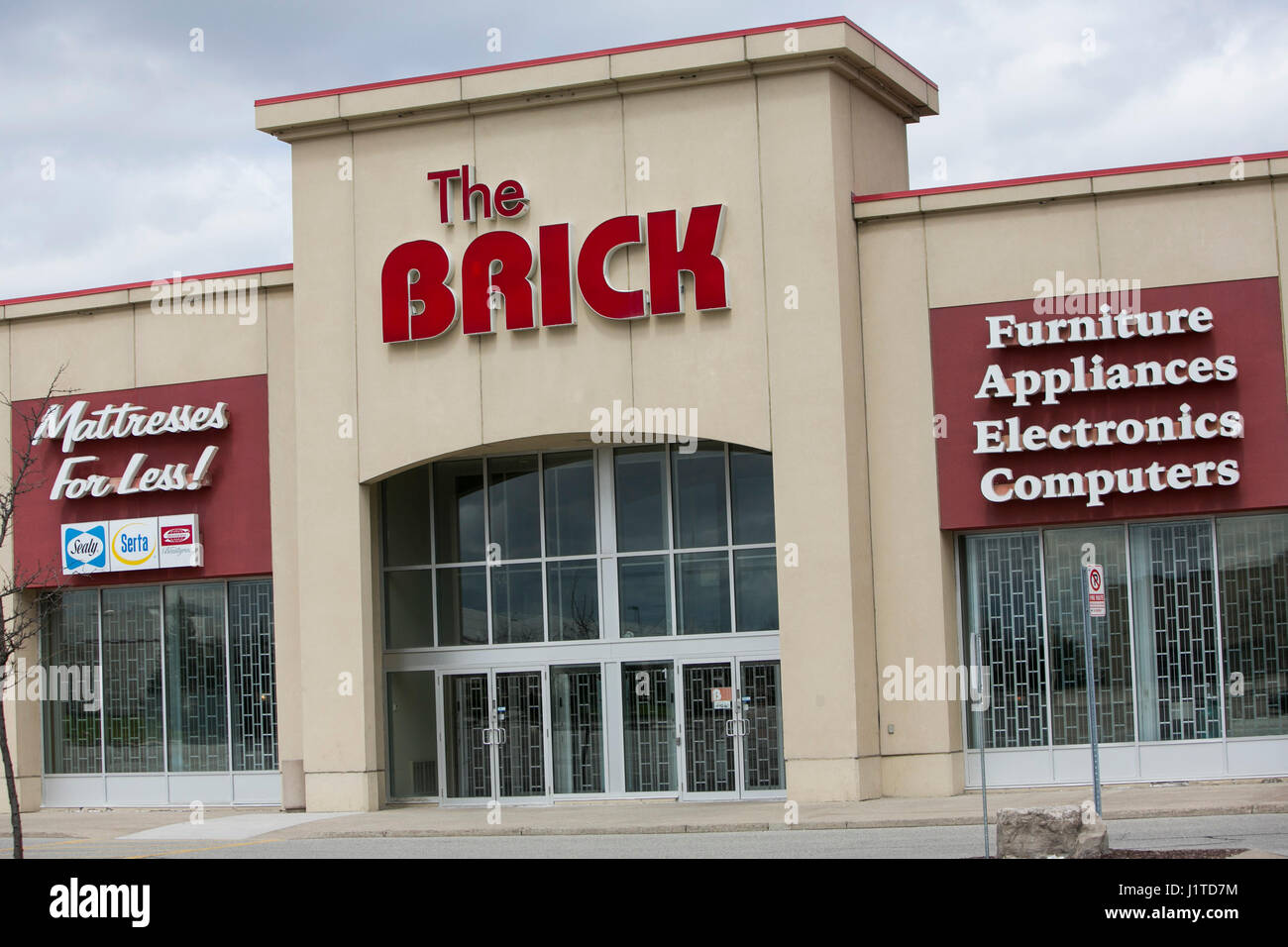 A logo sign outside of a The Brick retail store in Mississauga, Ontario ...