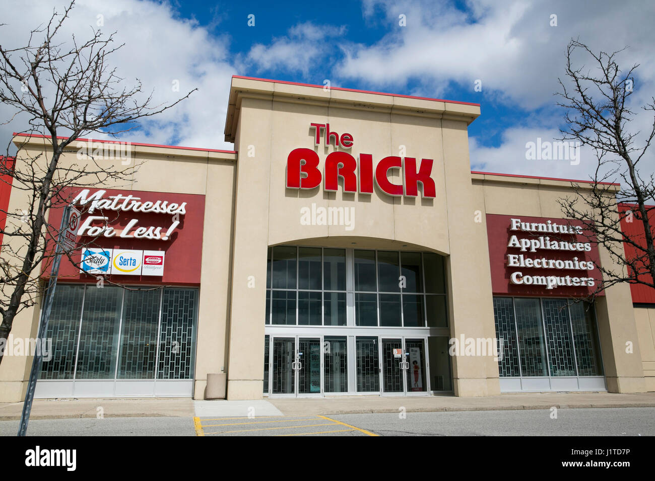 A logo sign outside of a The Brick retail store in Mississauga, Ontario ...