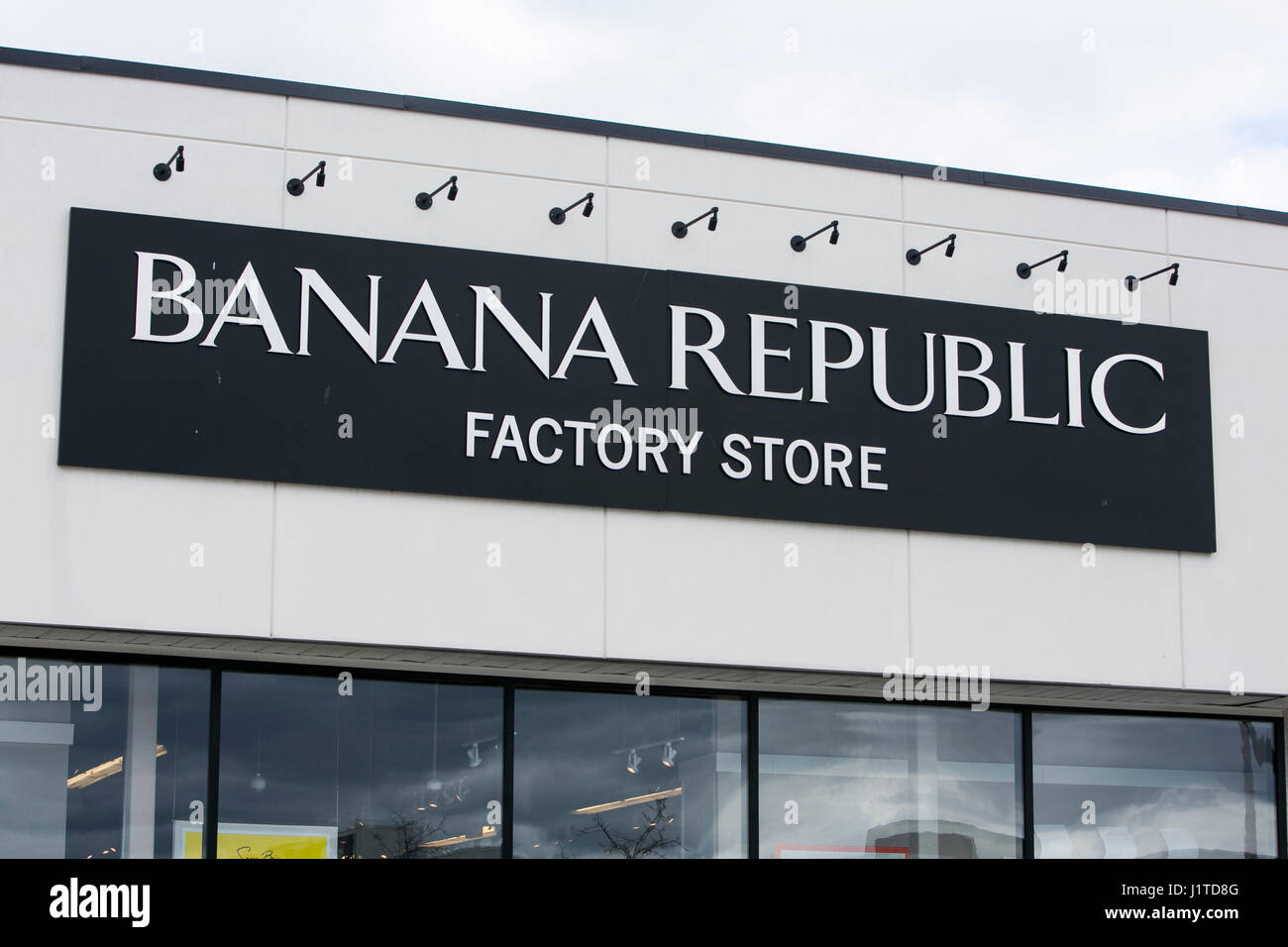 A logo sign outside of a Banana Republic Factory retail store in ...