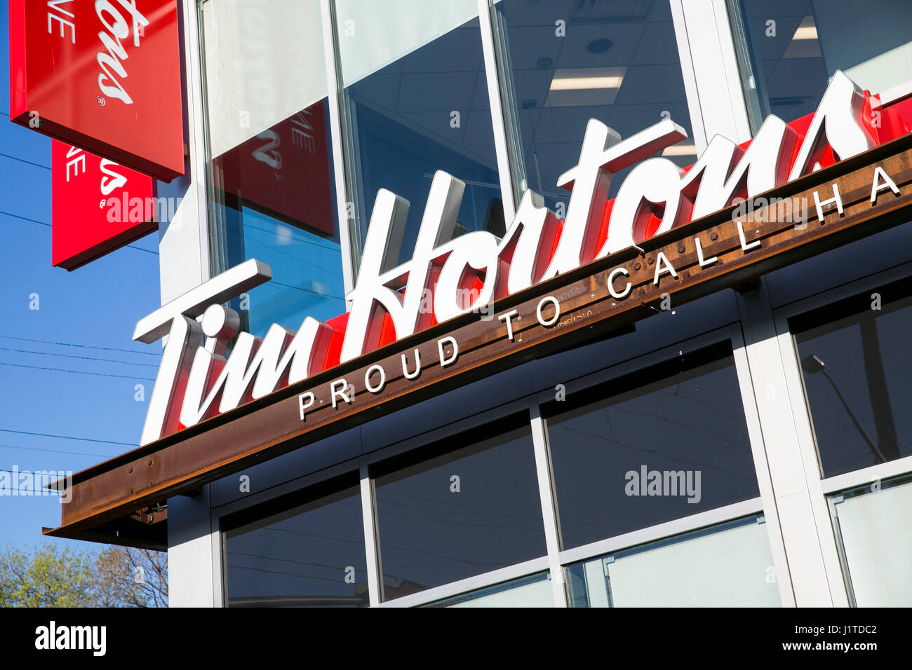 A logo sign outside of the location of the first Tim Hortons restaurant ...