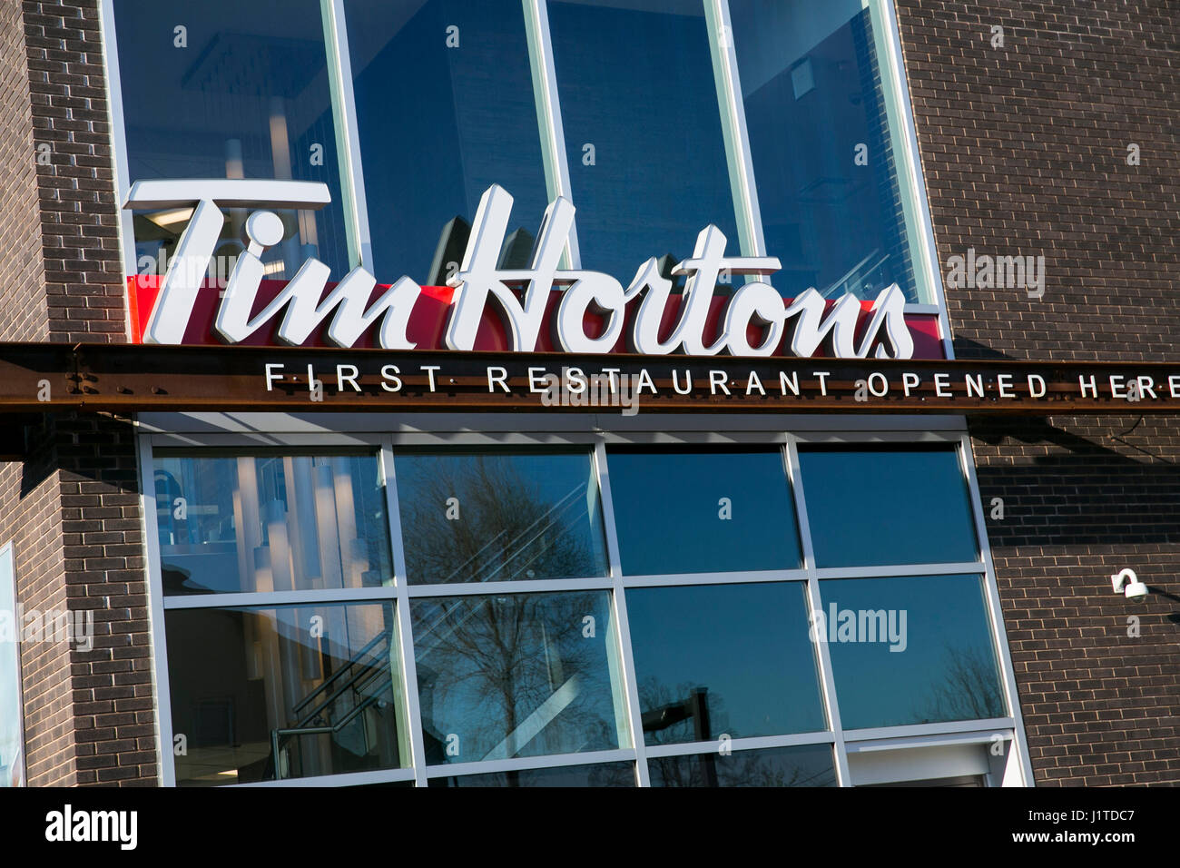A logo sign outside of the location of the first Tim Hortons restaurant ...