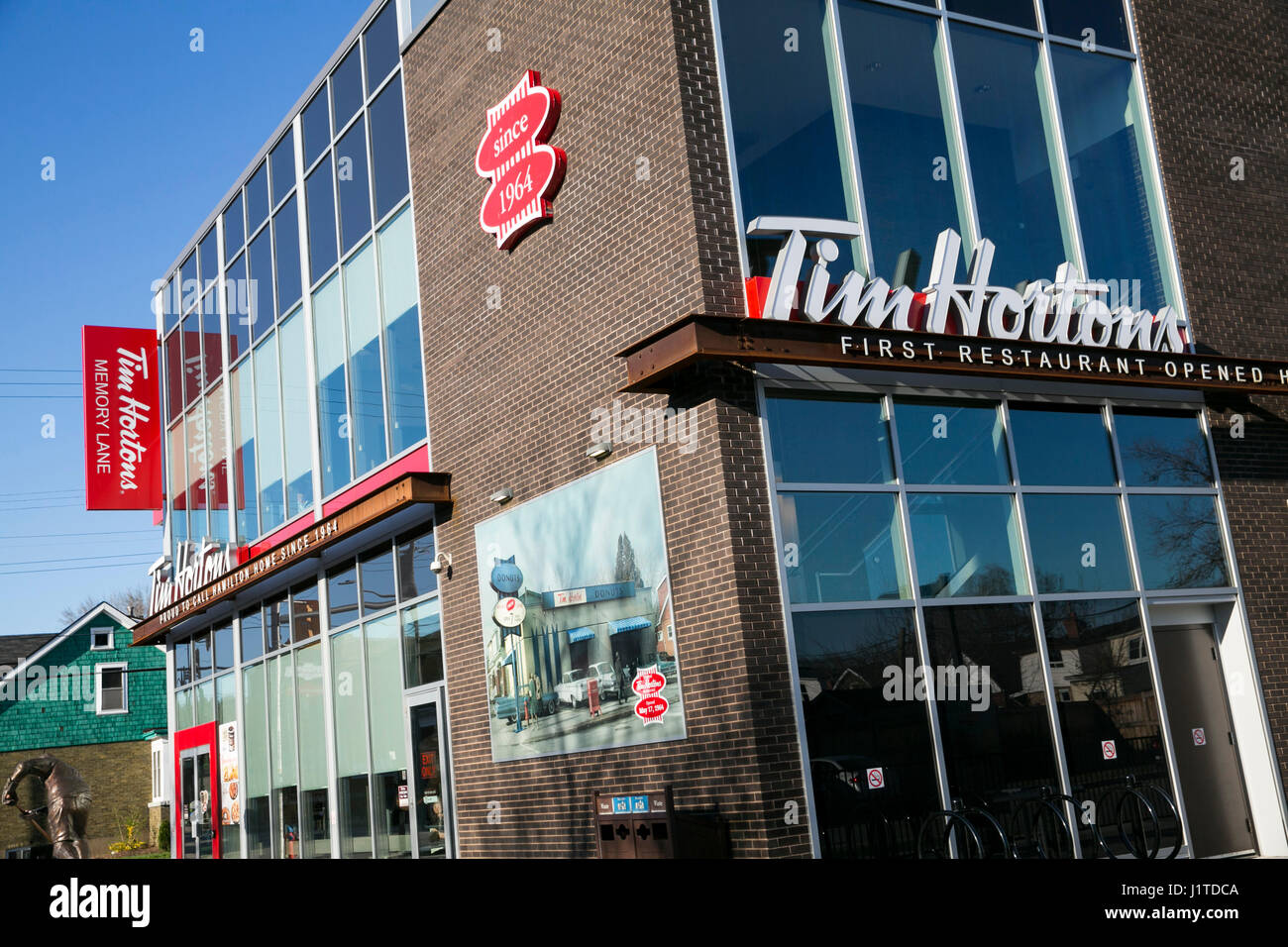 A logo sign outside of the location of the first Tim Hortons restaurant ...
