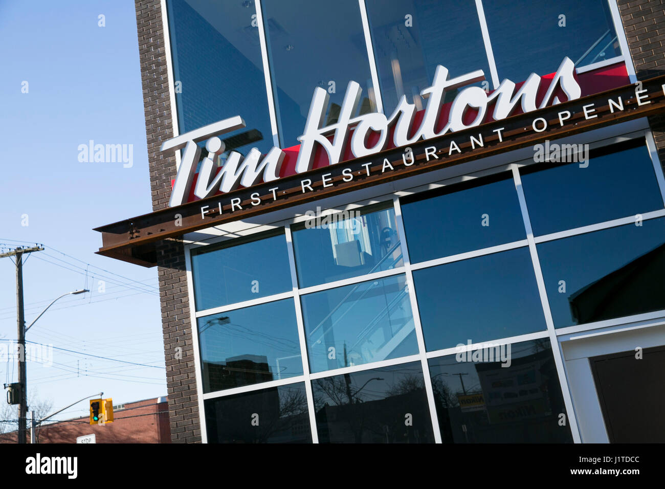 A logo sign outside of the location of the first Tim Hortons restaurant ...