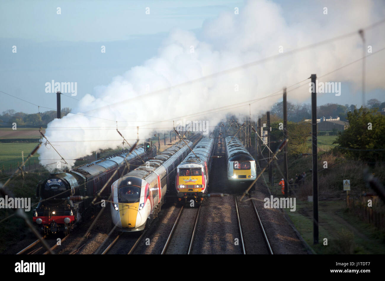 EDITORIAL USE ONLY (left to right) The Flying Scotsman and Virgin Trains' new Azuma travel in ...