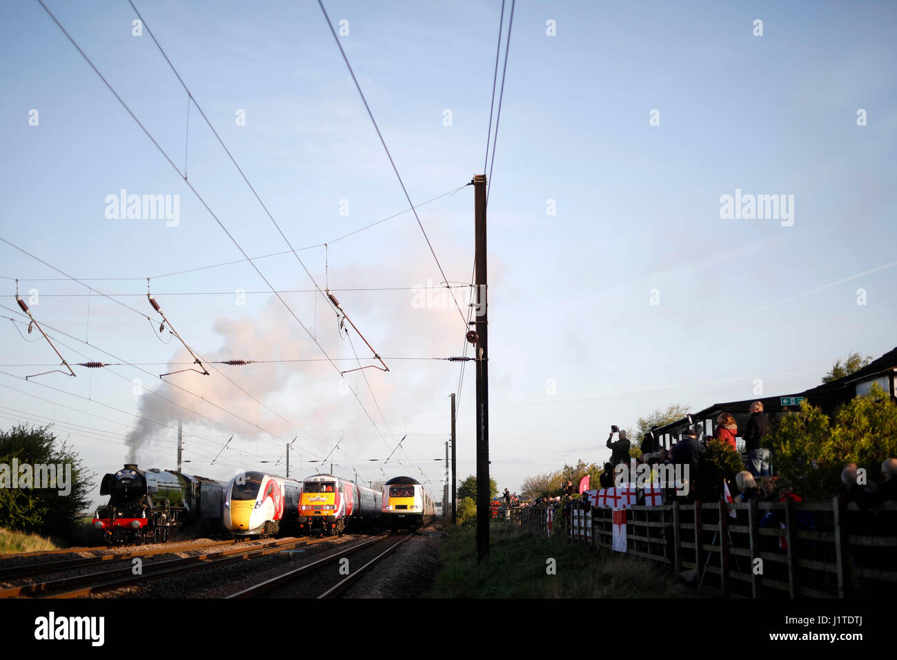 EDITORIAL USE ONLY (left to right) The Flying Scotsman and Virgin Trains' new Azuma travel in ...