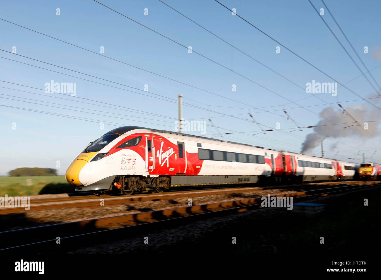 EDITORIAL USE ONLY Virgin Trains' new Azuma travels in the same direction alongside the The ...