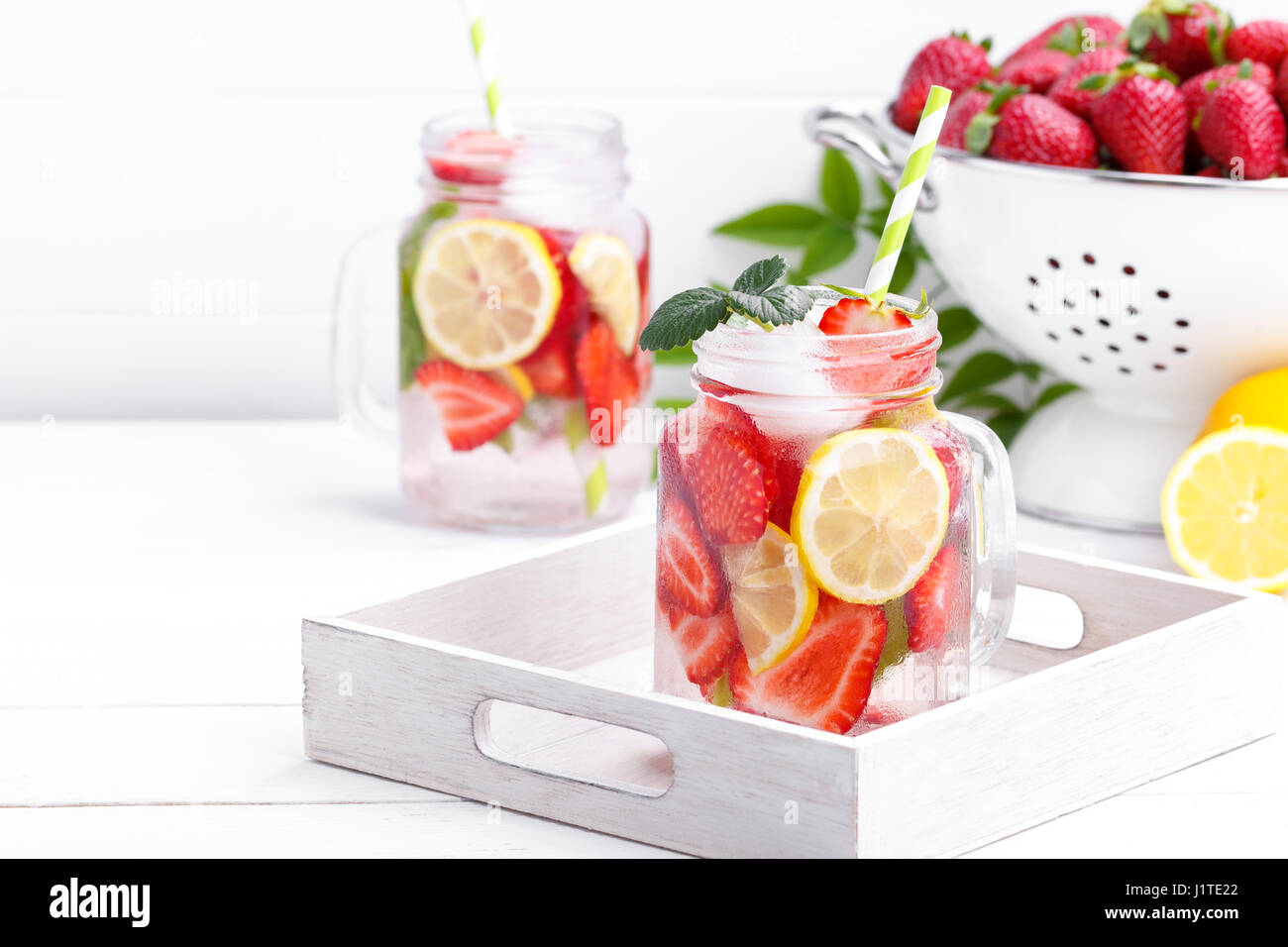 Detox fruit infused flavored water. Refreshing summer homemade cocktail ...