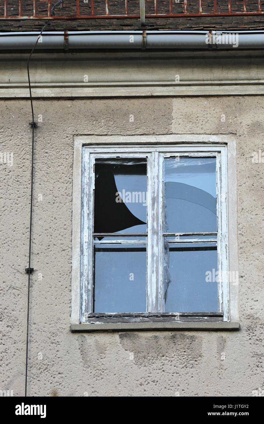 smashed window of an abandoned building Stock Photo - Alamy