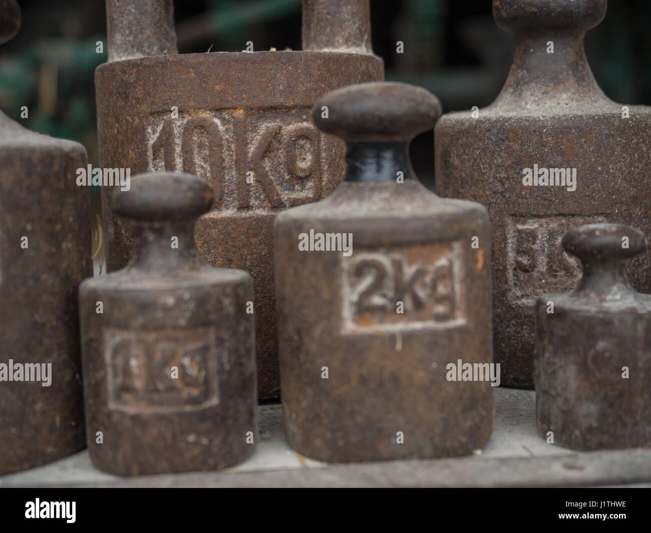 Old, metal weights of different size for a scale Stock Photo - Alamy