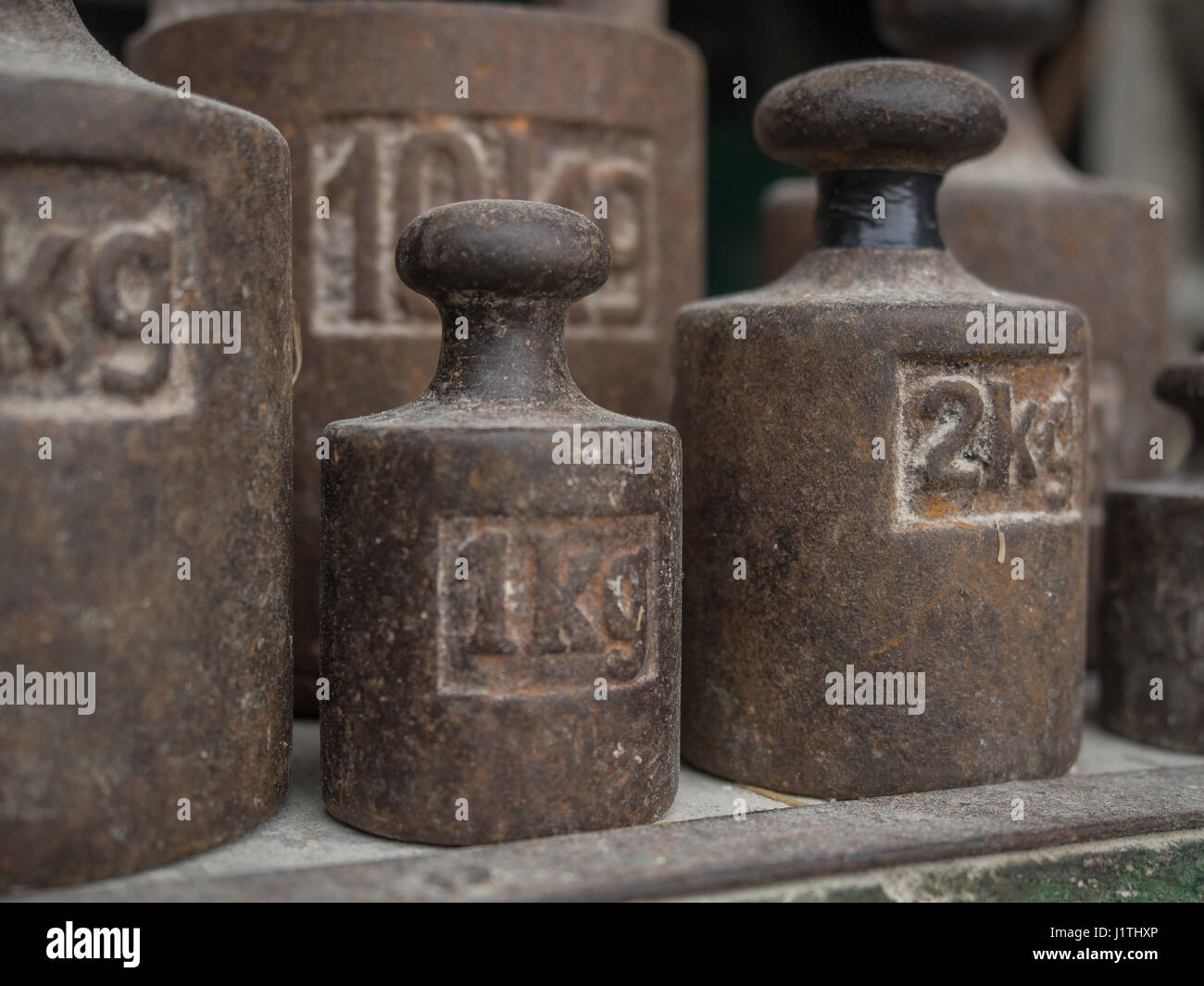 Old, metal weights of different size for a scale Stock Photo - Alamy