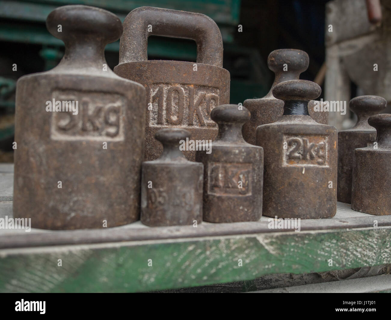 Old, metal weights of different size for a scale Stock Photo - Alamy