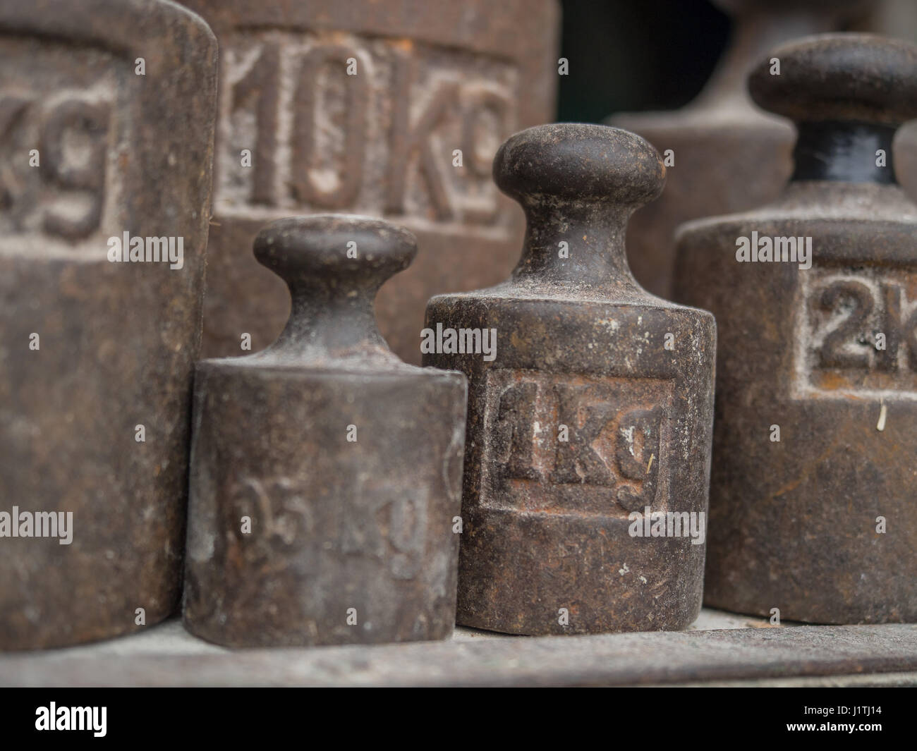 Old, metal weights of different size for a scale Stock Photo - Alamy