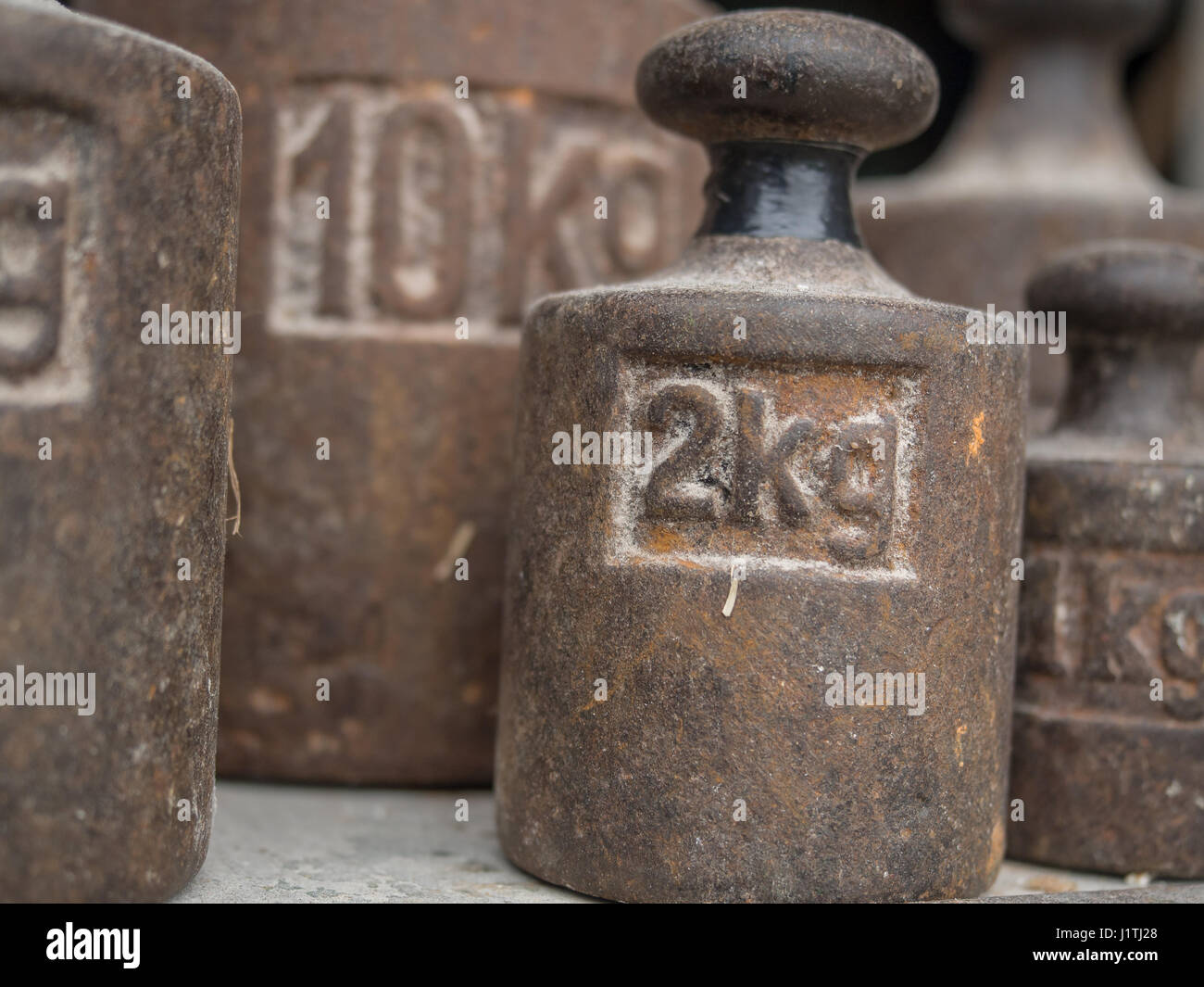 Old, metal weights of different size for a scale Stock Photo - Alamy
