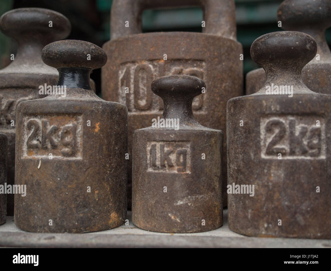 Old, metal weights of different size for a scale Stock Photo - Alamy