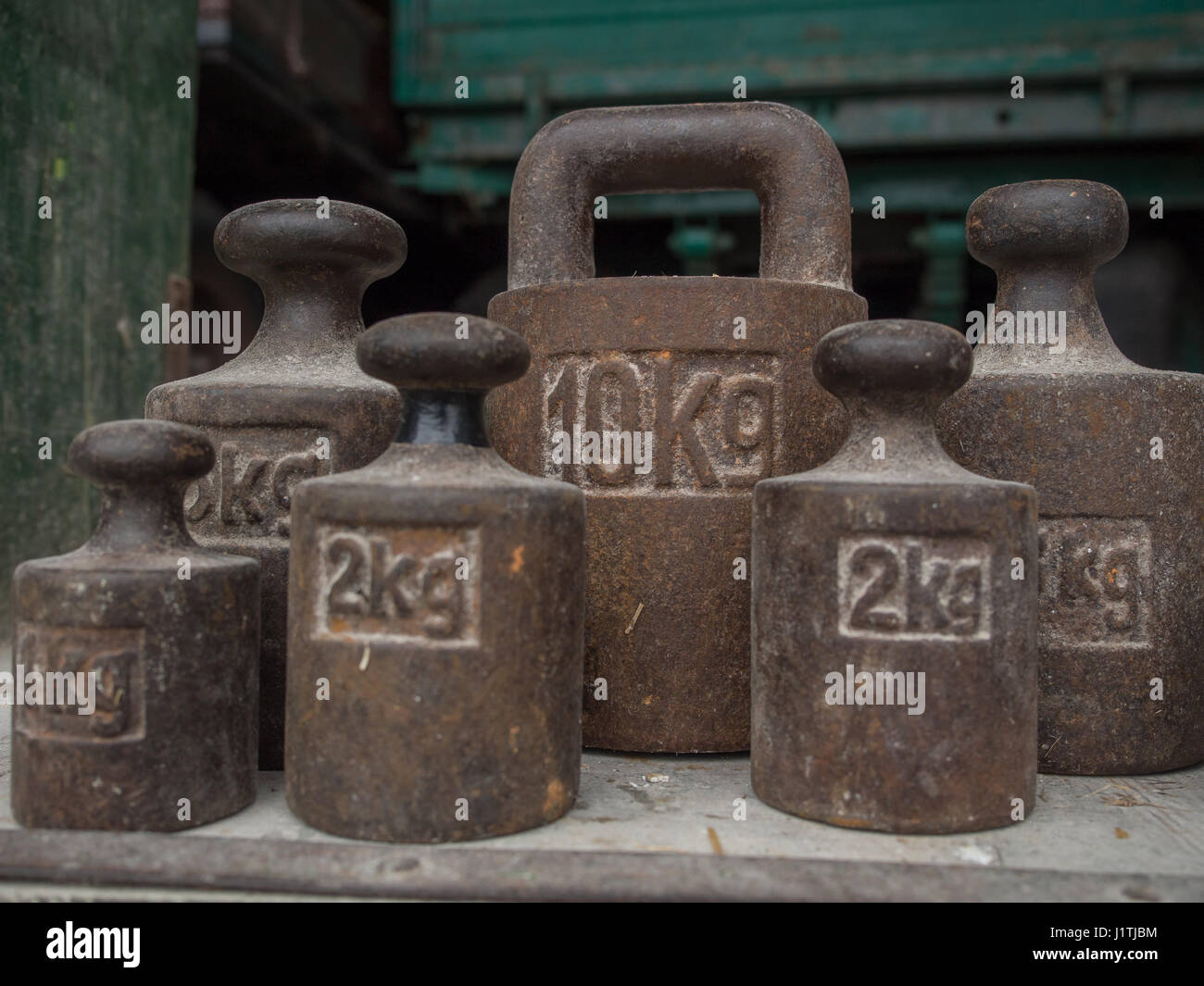 Old, metal weights of different size for a scale Stock Photo - Alamy