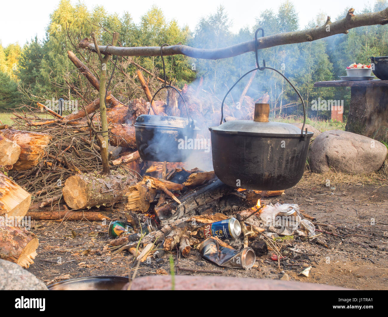 Cooking a meal on a campfire in metal vessels during a canoeing ...