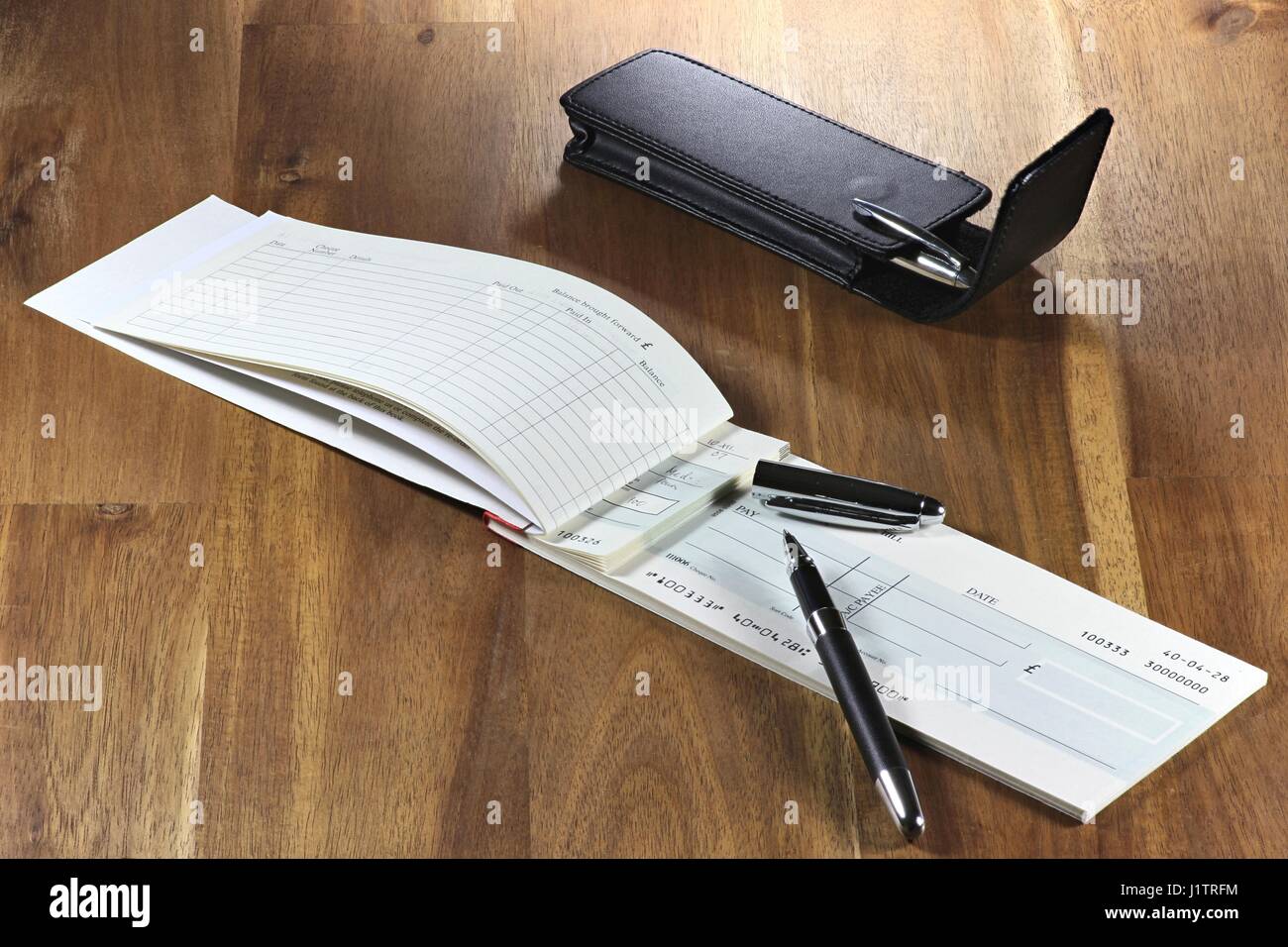 British checkbook on wooden desktop Stock Photo - Alamy