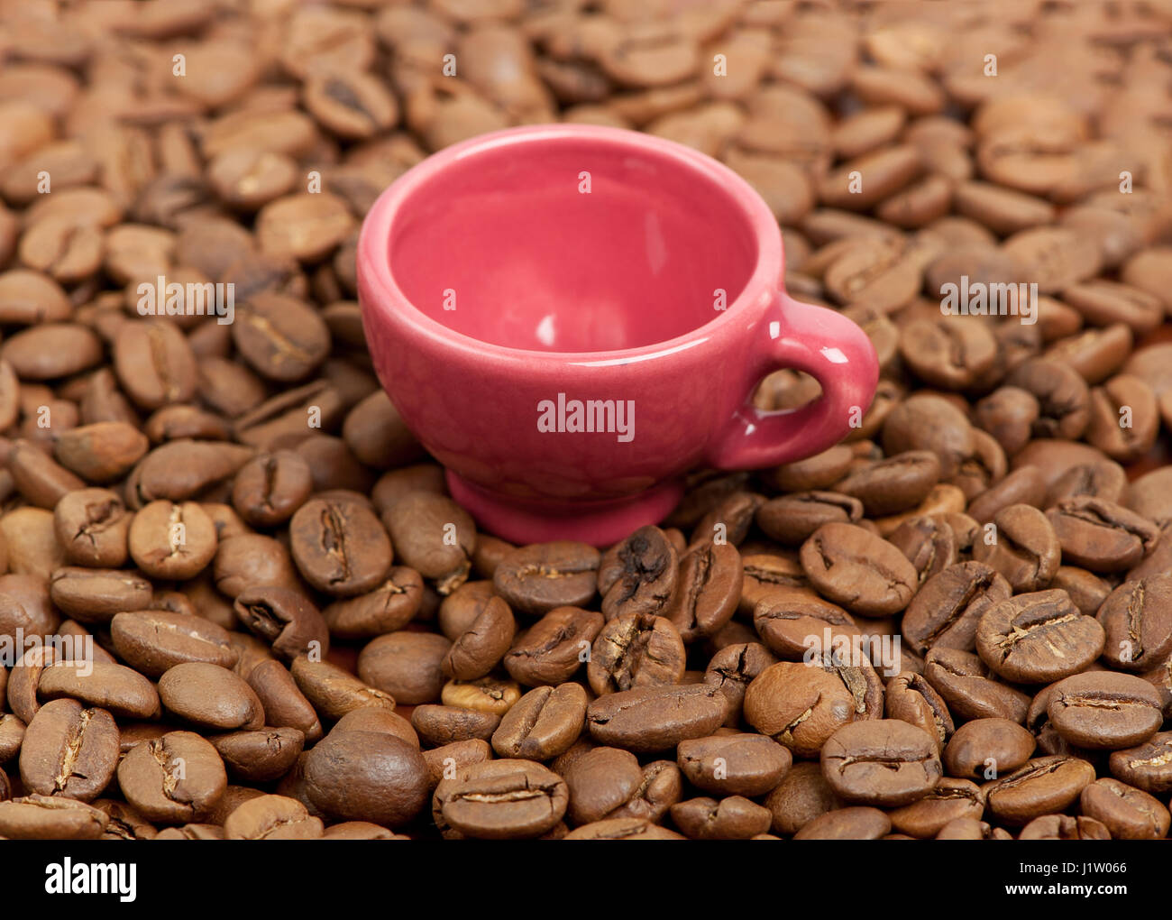 Cup in coffee beans Stock Photo - Alamy