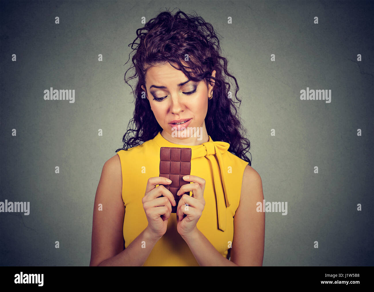 Portrait of a woman tired of diet restrictions craving sweets chocolate ...