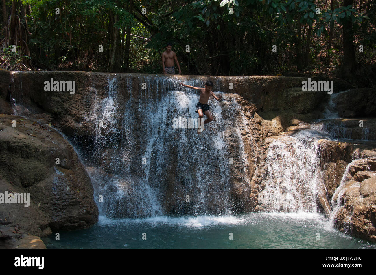 Boy jumping down the Waterfall in the Jungles Stock Photo - Alamy