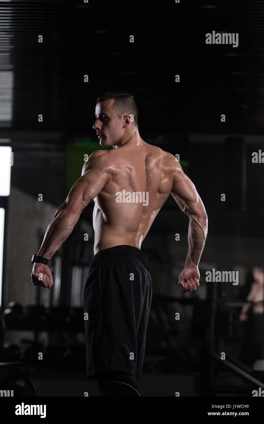 Healthy Man Standing Strong In The Gym And Flexing Muscles - Muscular ...