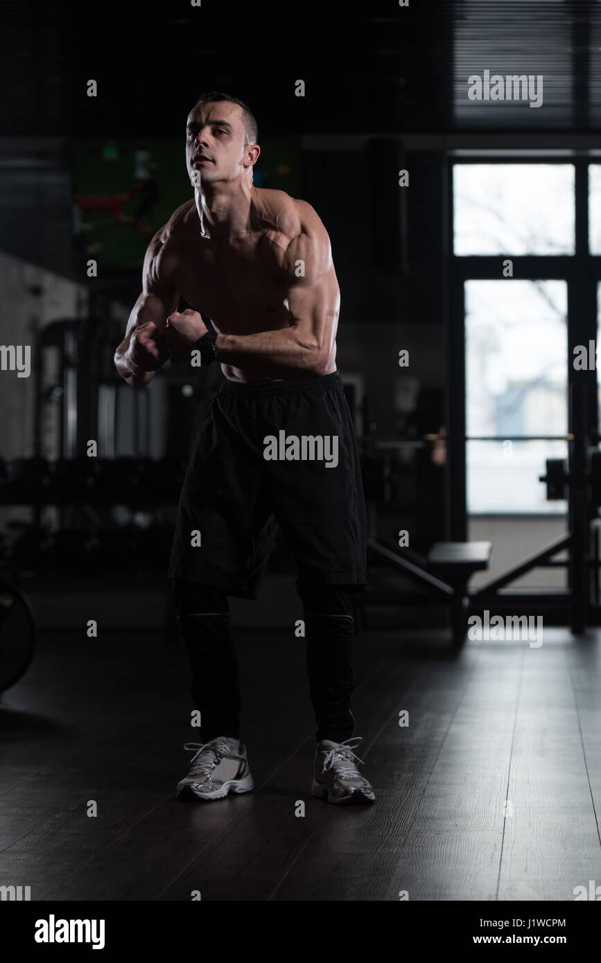 Healthy Man Standing Strong In The Gym And Flexing Muscles - Muscular ...