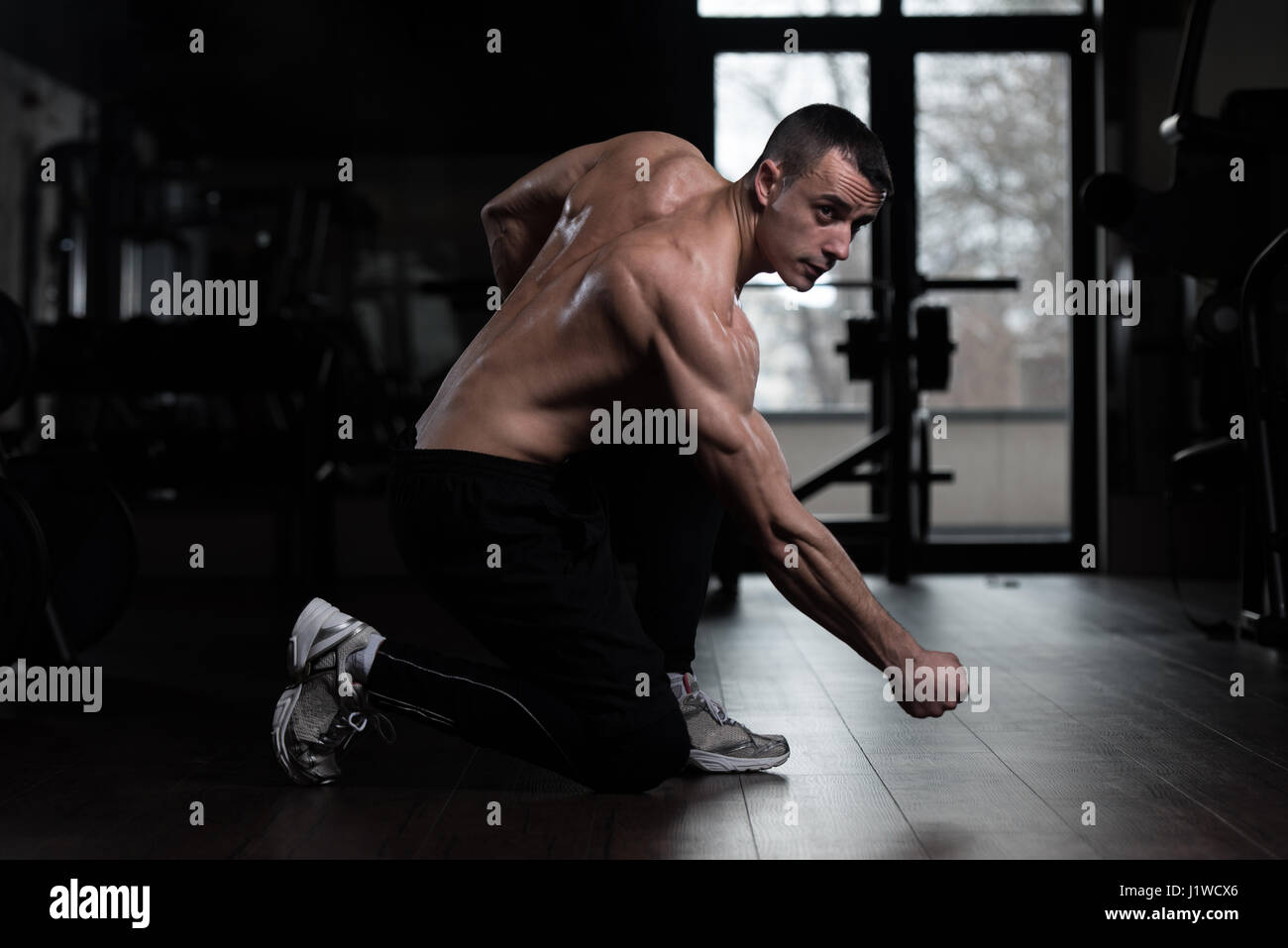 Healthy Man Standing Strong In The Gym And Flexing Muscles - Muscular ...
