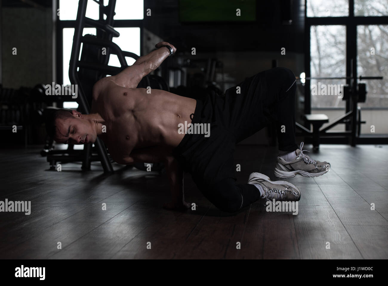 Young Man Athlete Doing Extreme Handstand On One Hand As Part Of ...