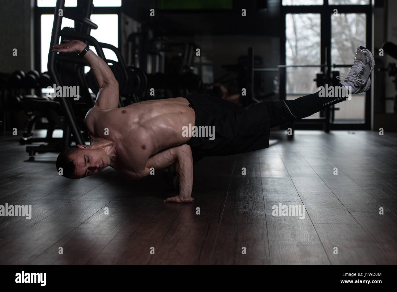 Young Man Athlete Doing Extreme Handstand On One Hand As Part Of ...