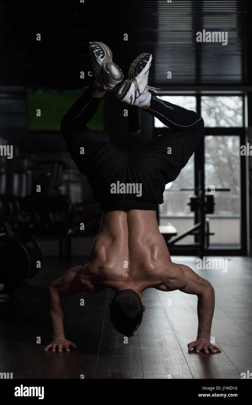 Young Man Athlete Doing Extreme Pushups Handstand As Part Of ...