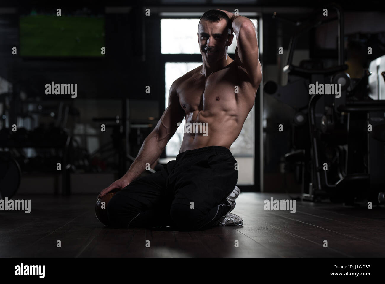 Healthy Man Standing Strong In The Gym And Flexing Muscles - Muscular ...